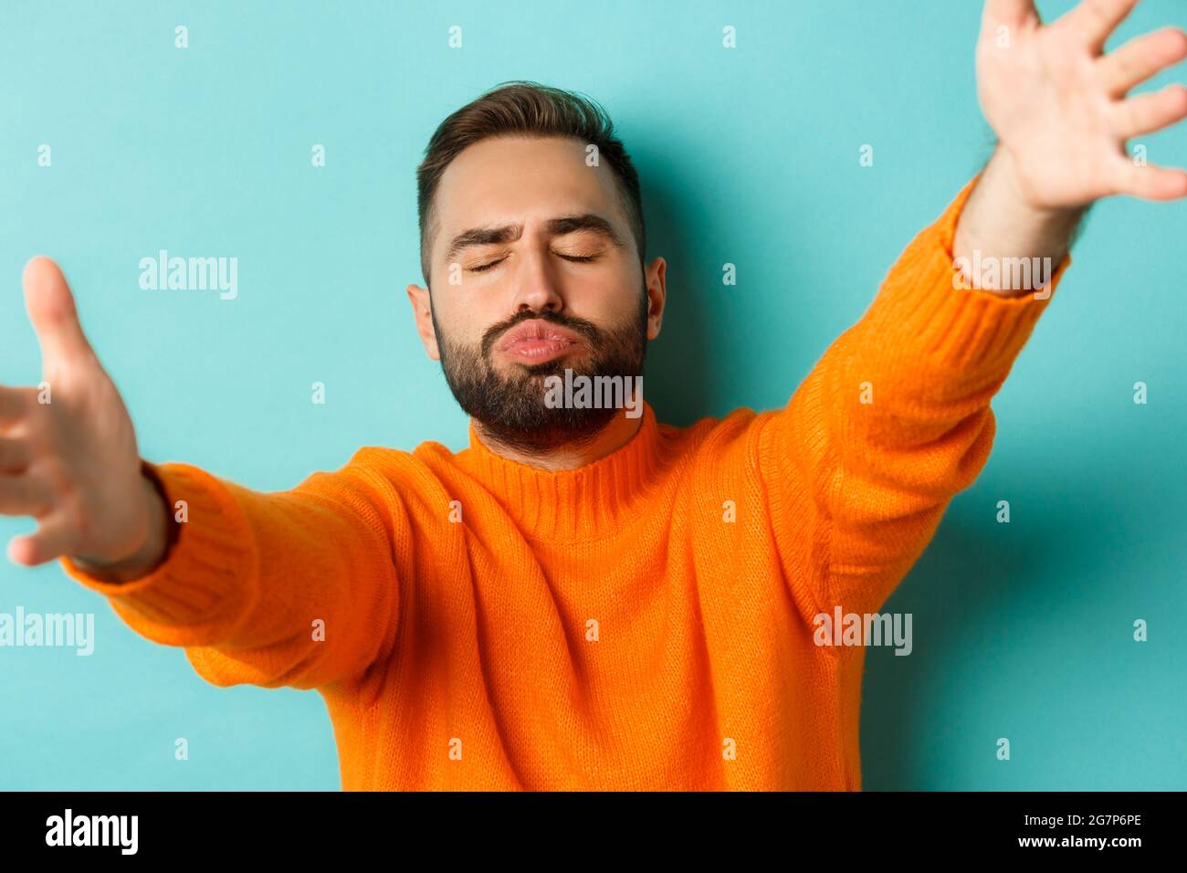 Close-up of handsome happy man reaching hands forward, stretching arms ...