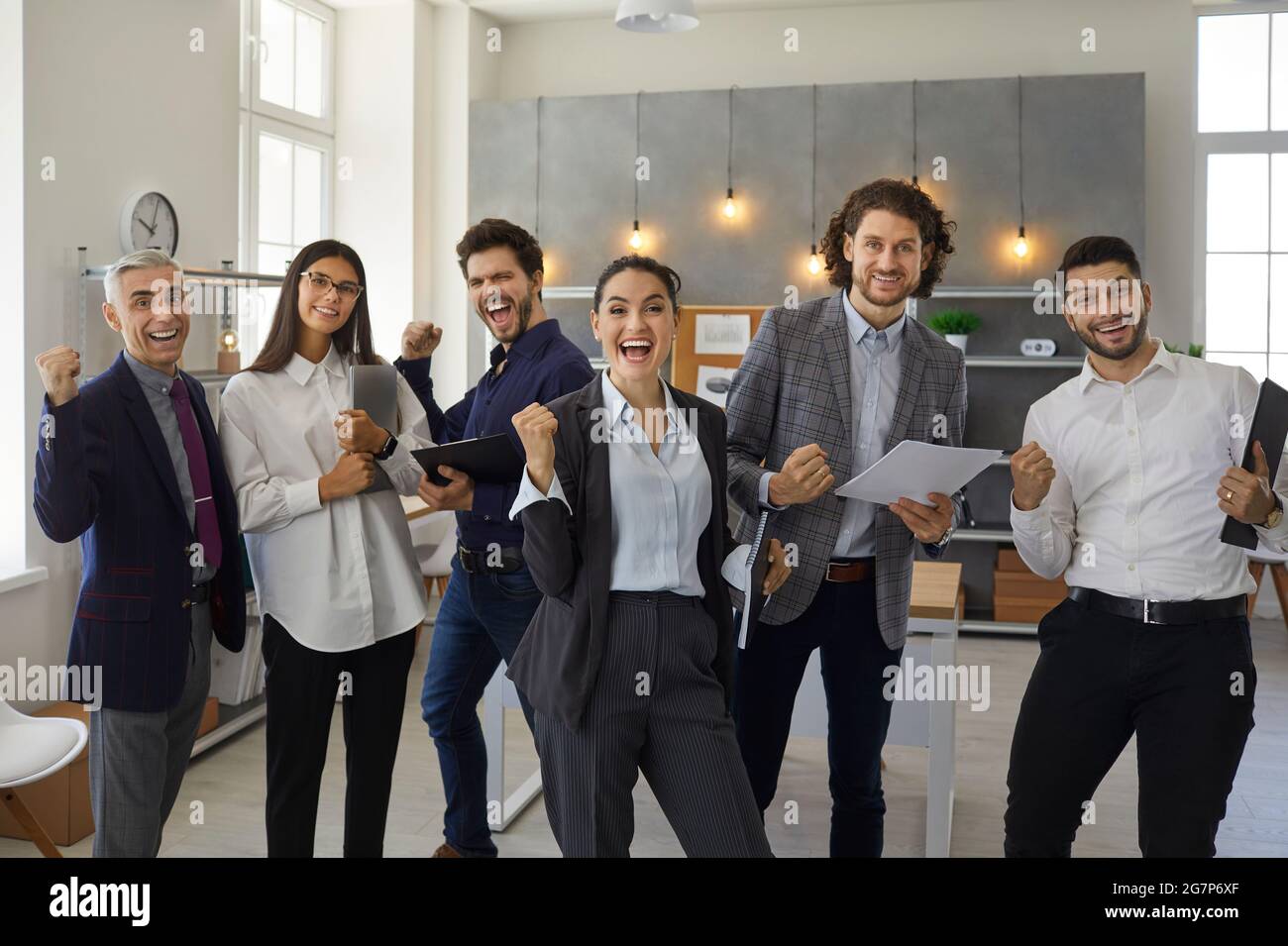 Happy triumphant business team celebrating giving successful ...