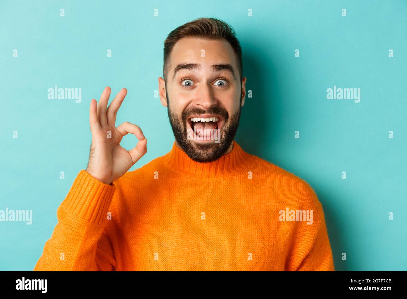Impressed handsome man showing okay sign, recommending something good ...