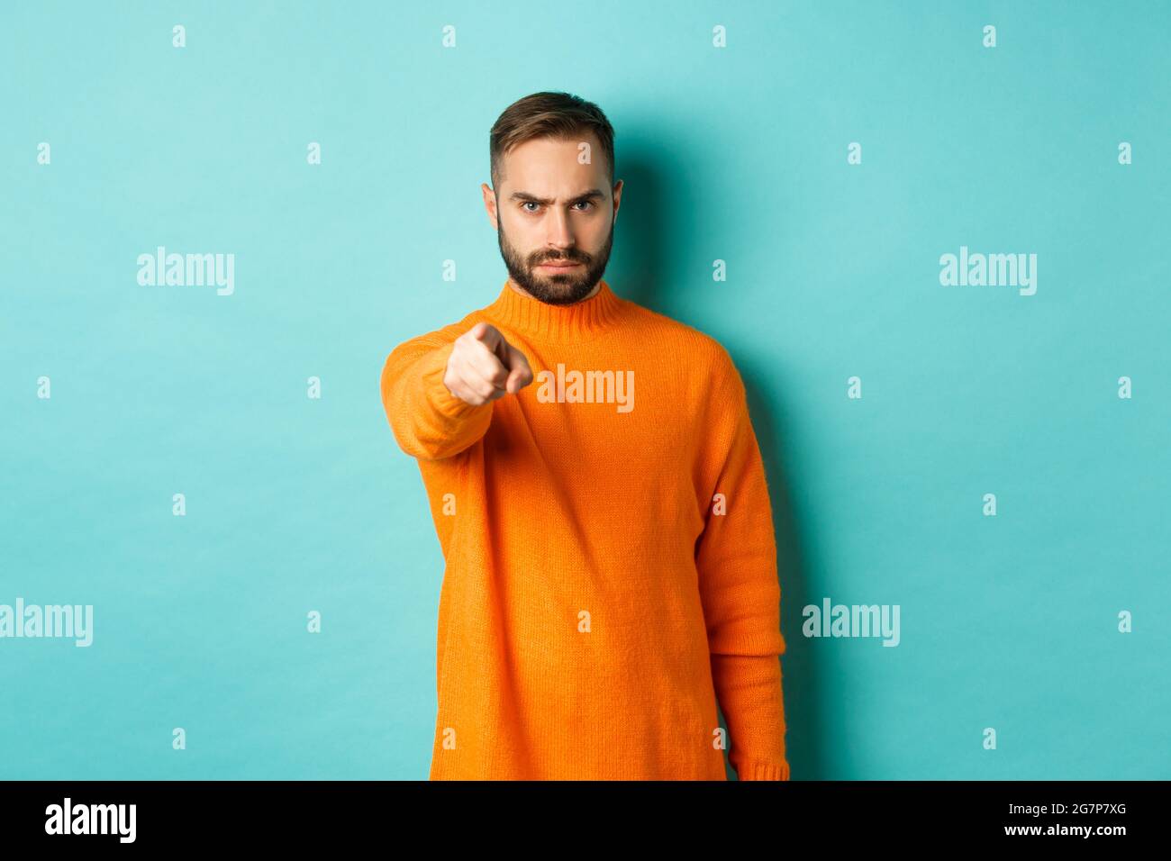 Confident man blame you, frowning and pointing finger at camera, accuse ...