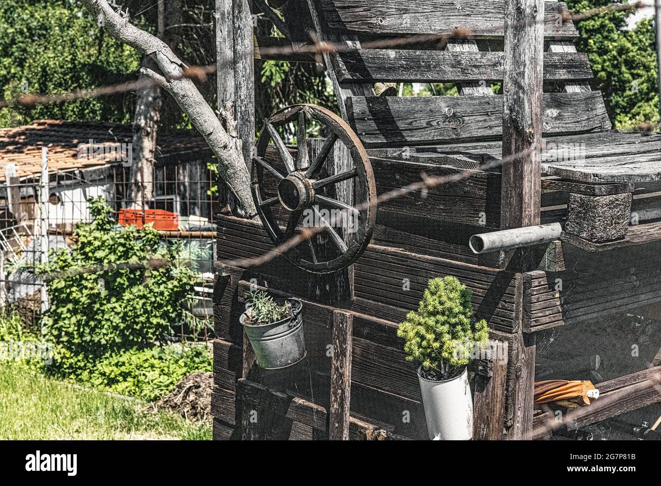 Wooden chair behind a barbed wire fence in the backyard Stock Photo - Alamy