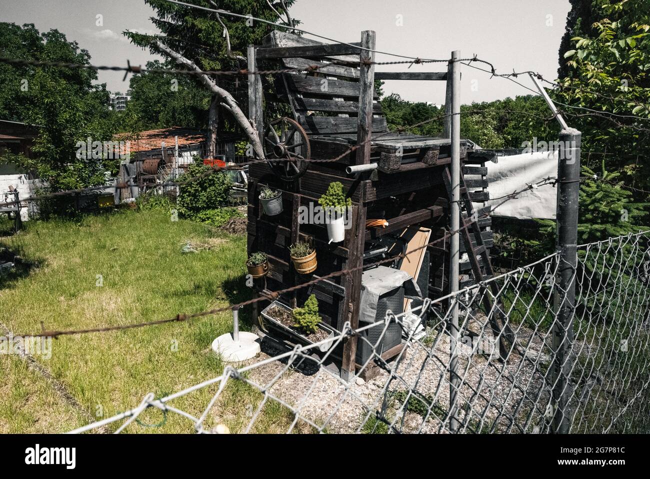 Wooden chair behind a barbed wire fence in the backyard Stock Photo - Alamy