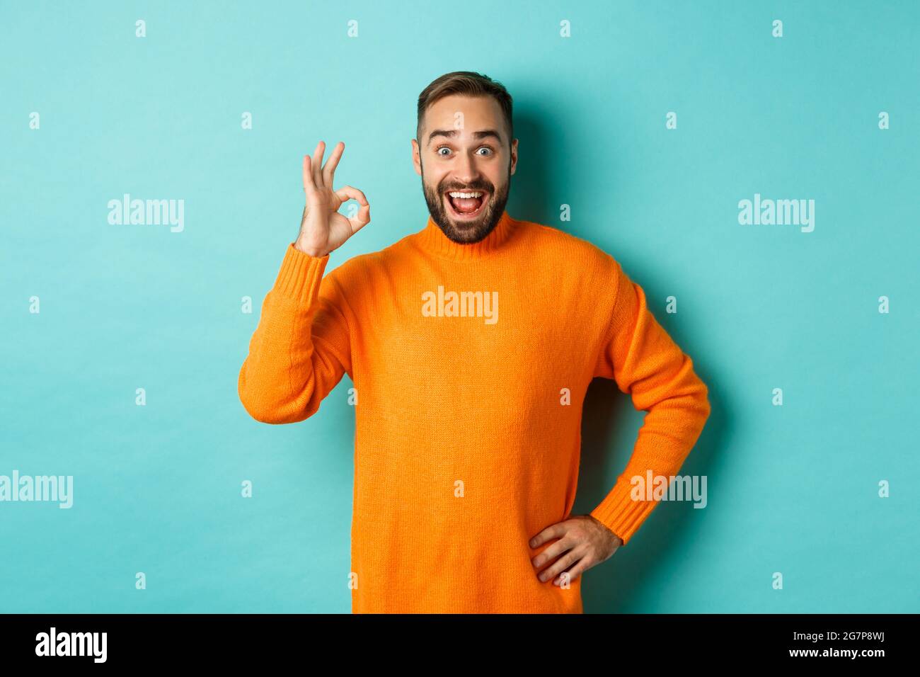 Impressed man recommending promo, showing okay sign and smiling amazed ...