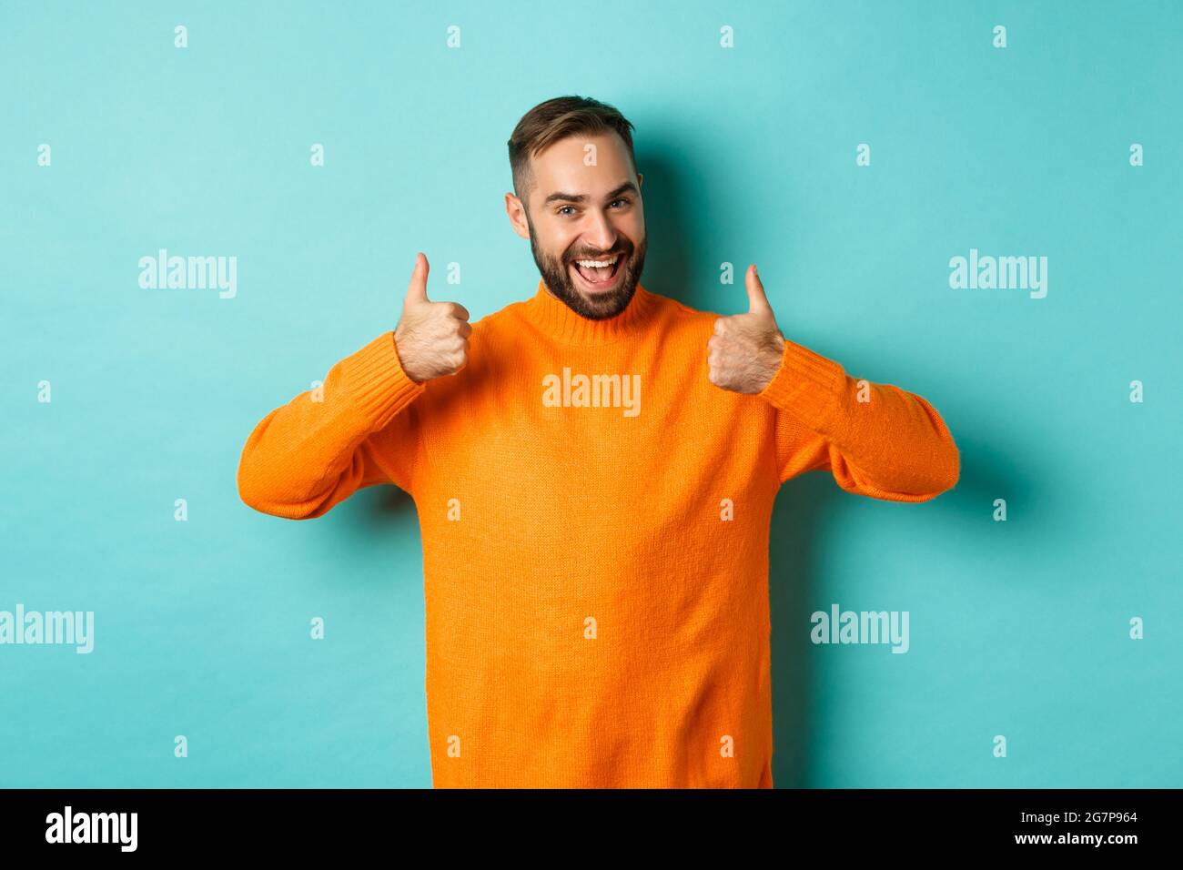 Handsome man expressing support, showing thumb up, encourage you ...