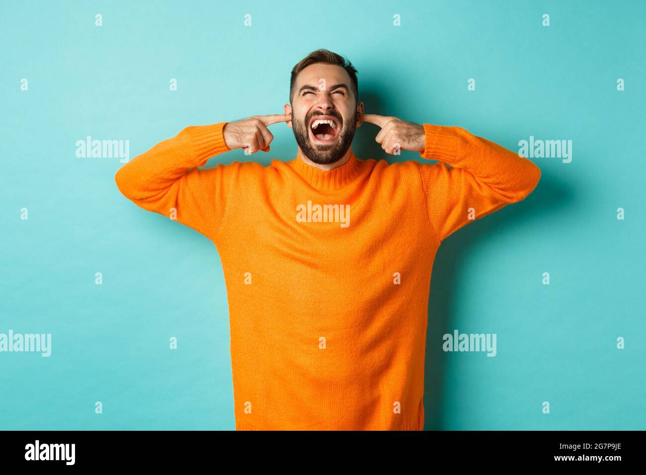 Frustrated and annoyed man shouting at neighbours upstairs, shut ears ...