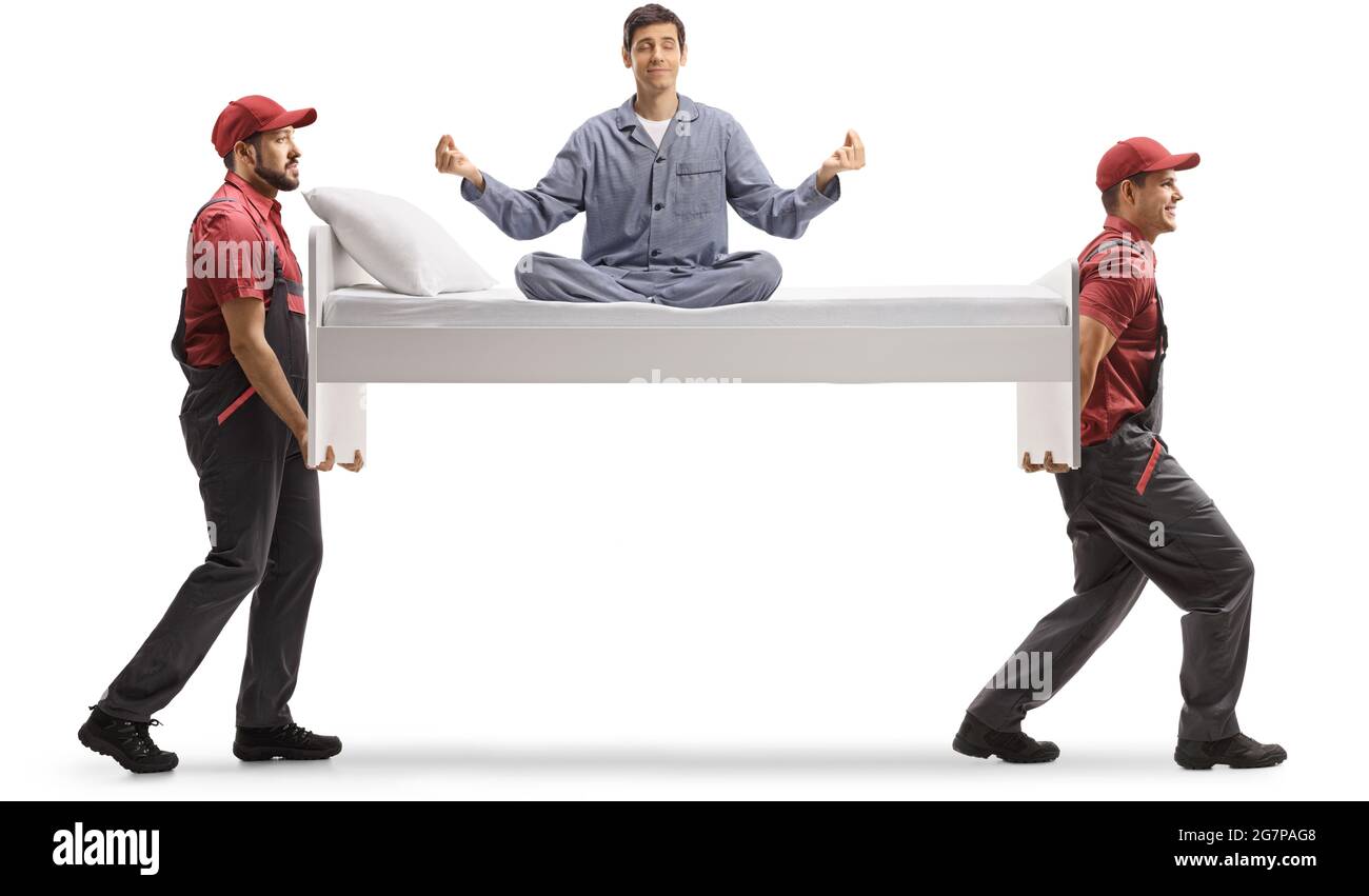 Movers carrying a bed with man in pajamas sitting and meditating ...