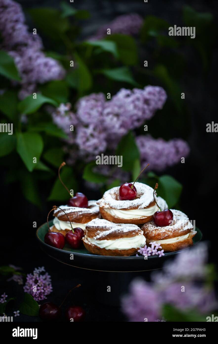 Cream puff rings (choux pastry) decorated with fresh cherry Stock Photo ...