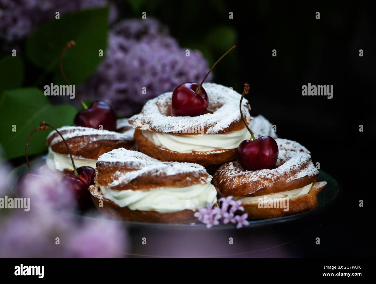 Cream puff rings (choux pastry) decorated with fresh cherry Stock Photo ...