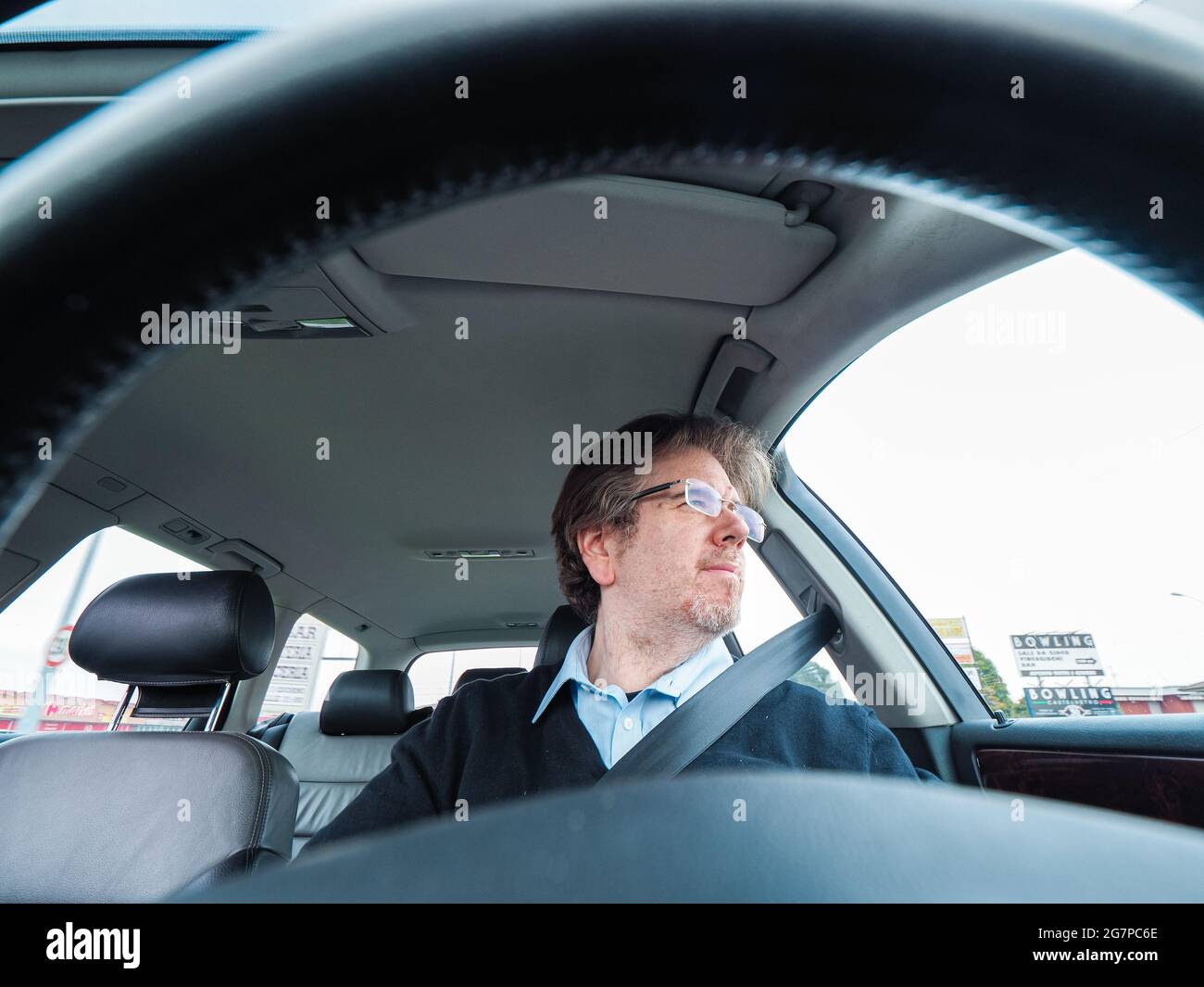 Caucasian male driving a car visible from a car dashboard Stock Photo ...