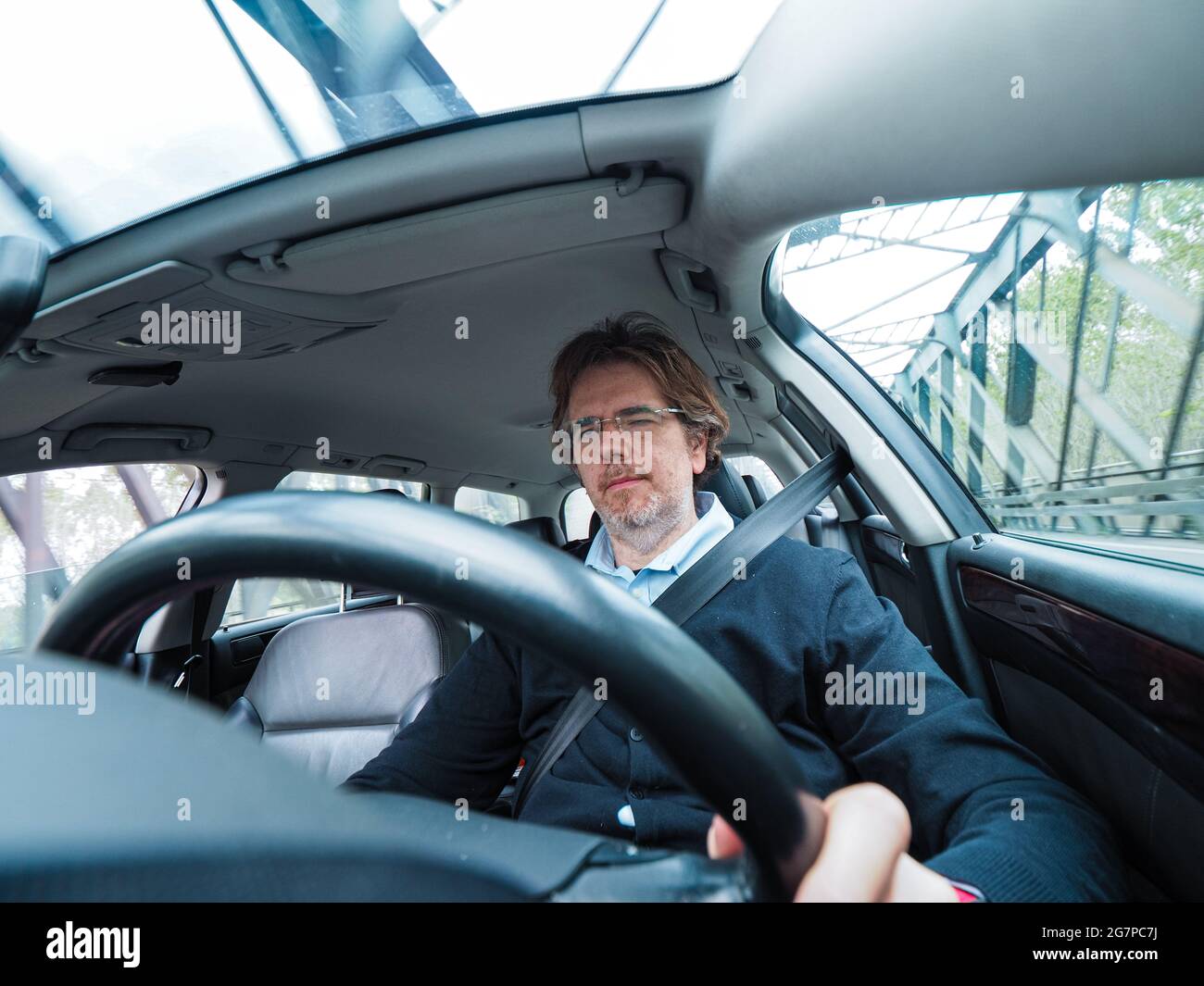 Mid-aged Caucasian male driving a car Stock Photo - Alamy