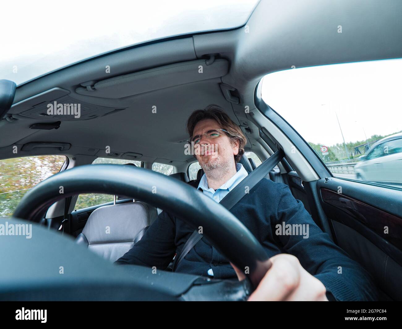 Mid-aged Caucasian male driving a car Stock Photo - Alamy