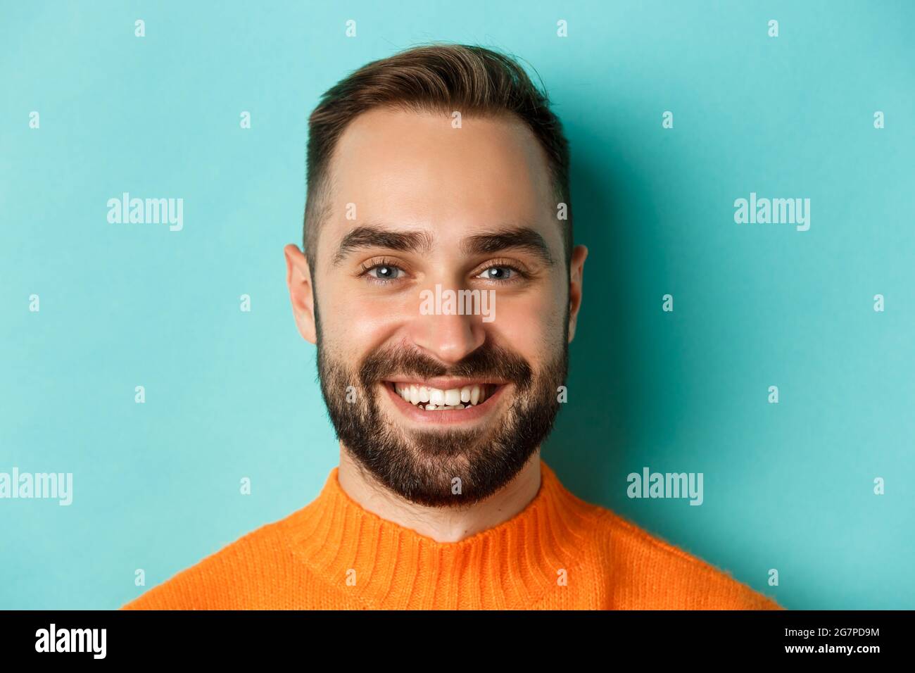 Headshot of handsome caucasian man with beard smiling happy at camera ...