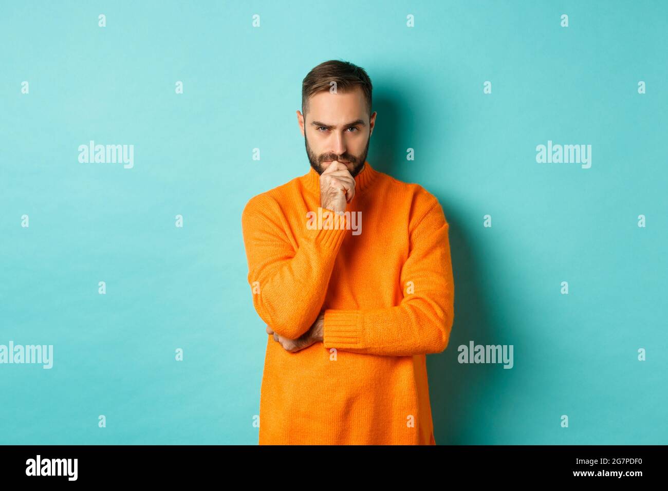 Thougtful young man making decision, looking serious and thinking ...