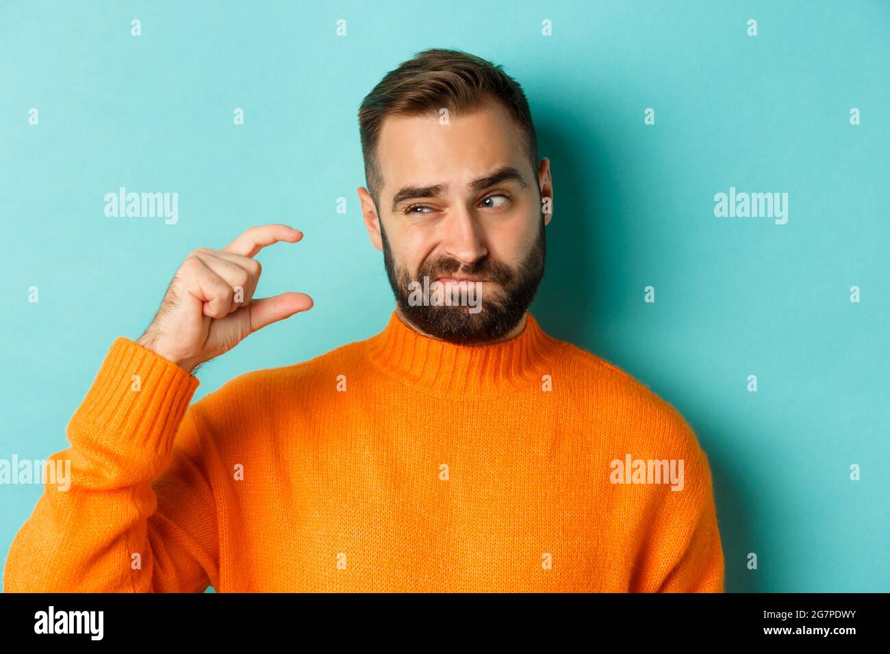 Close-up of caucasian man showing small or little with fingers ...