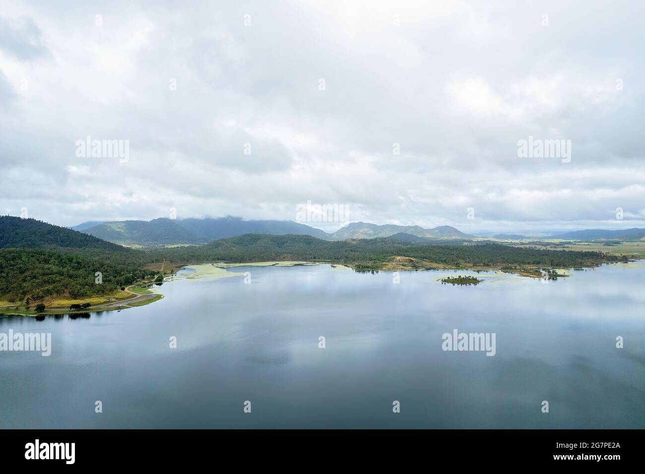 Calm water and cloud reflections across Kinchant Dam, Queensland ...
