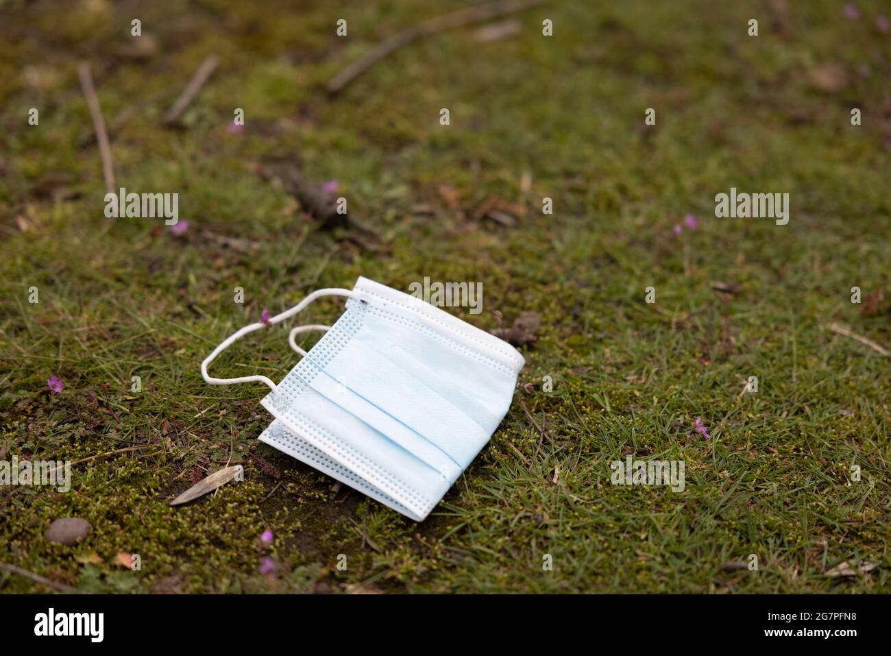 Folded mask on the ground outdoors - covid19, pandemic, mandatory masks ...