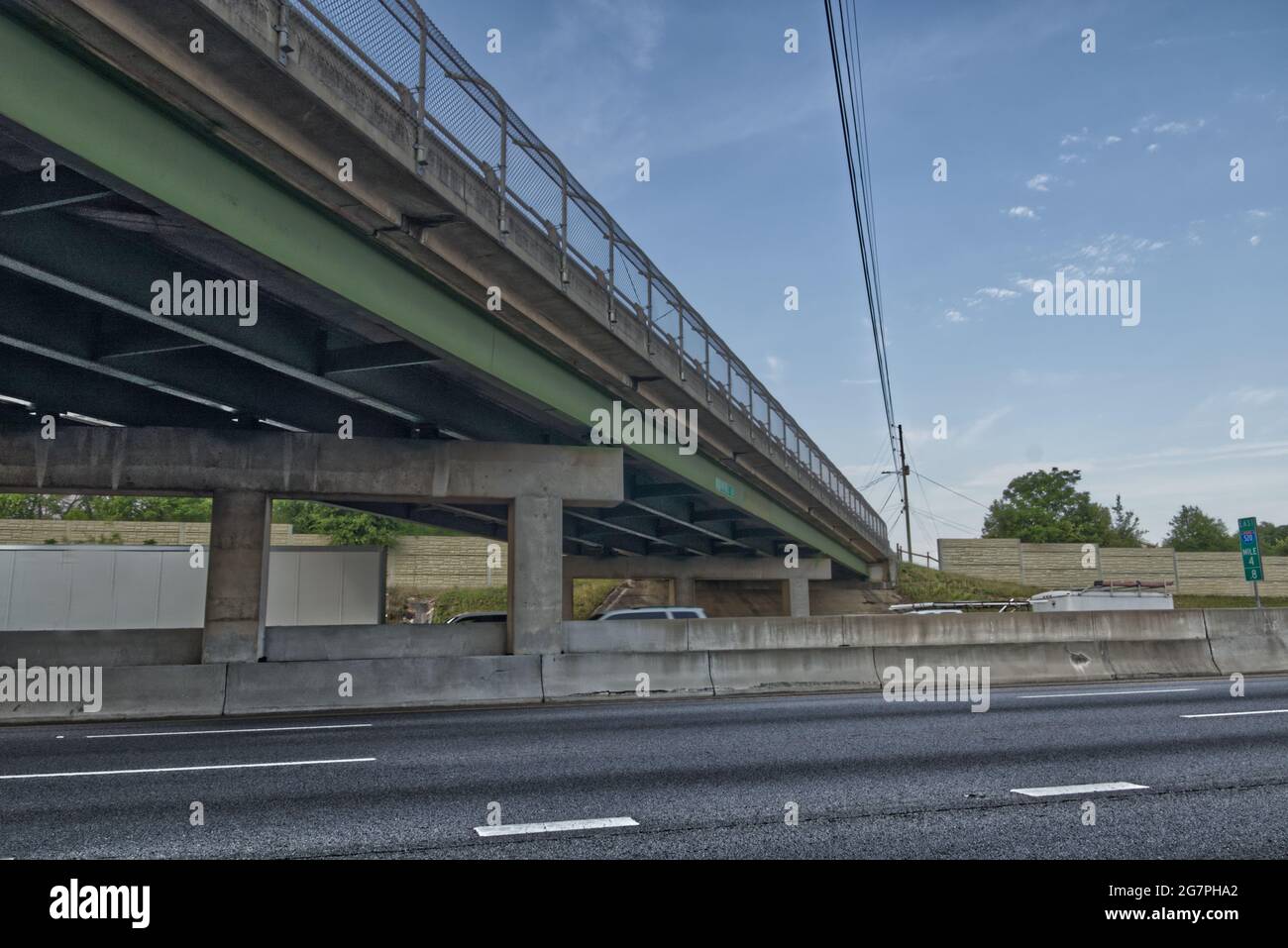 Highway Bridge with a fence and traffic jam behind concrete divider ...