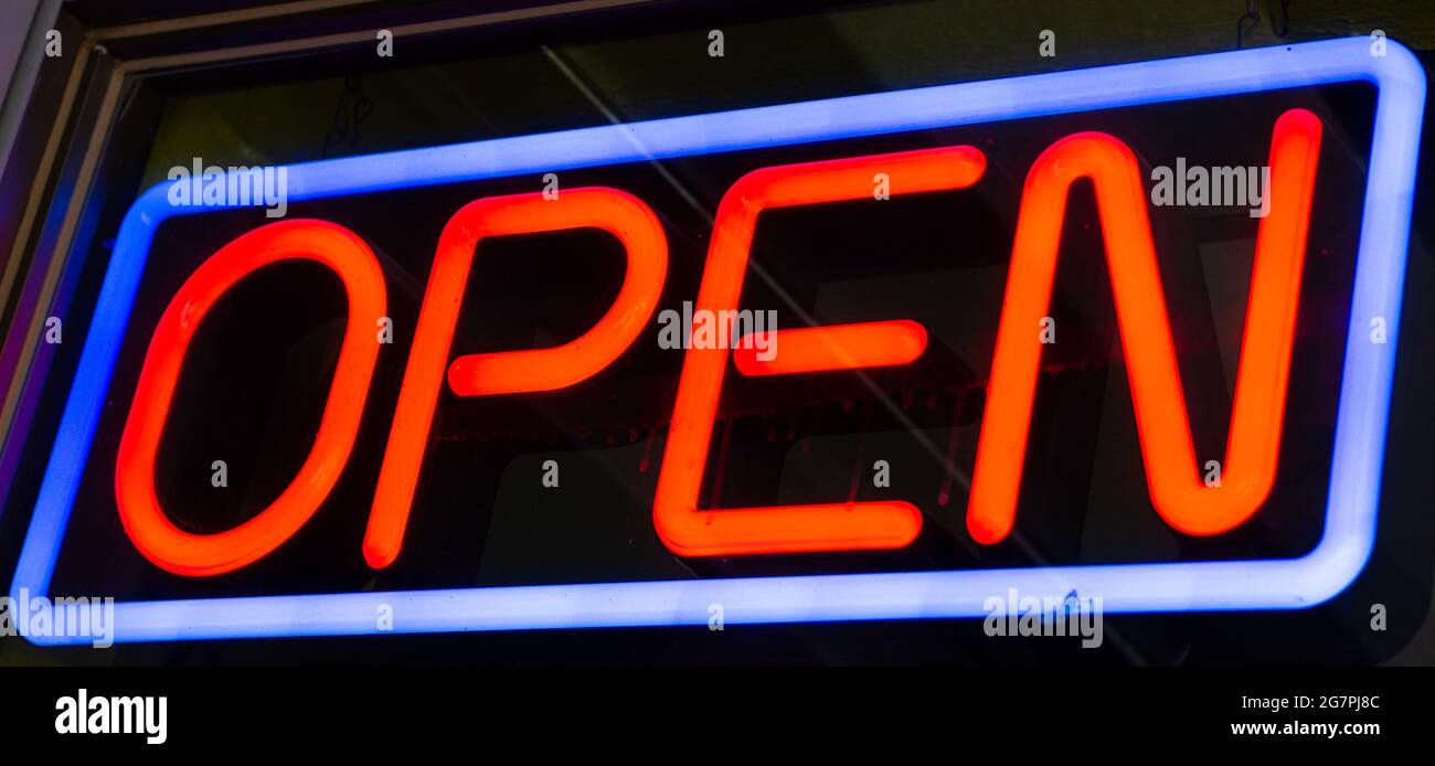 Blue and red neon open sign at night. Store, bar, business concepts ...