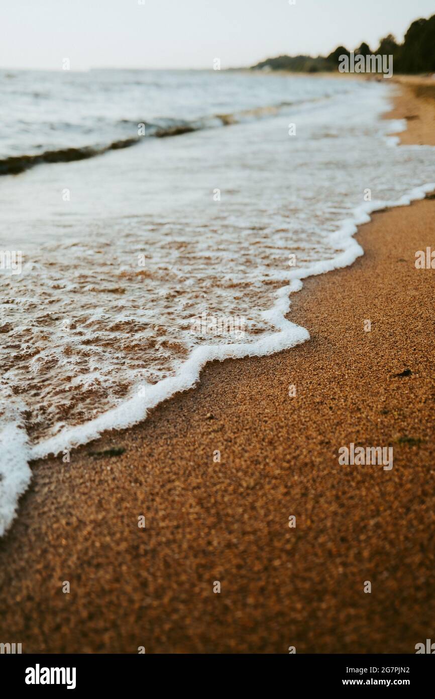 Beautiful scenery of the beach with splashing sea waves Stock Photo - Alamy