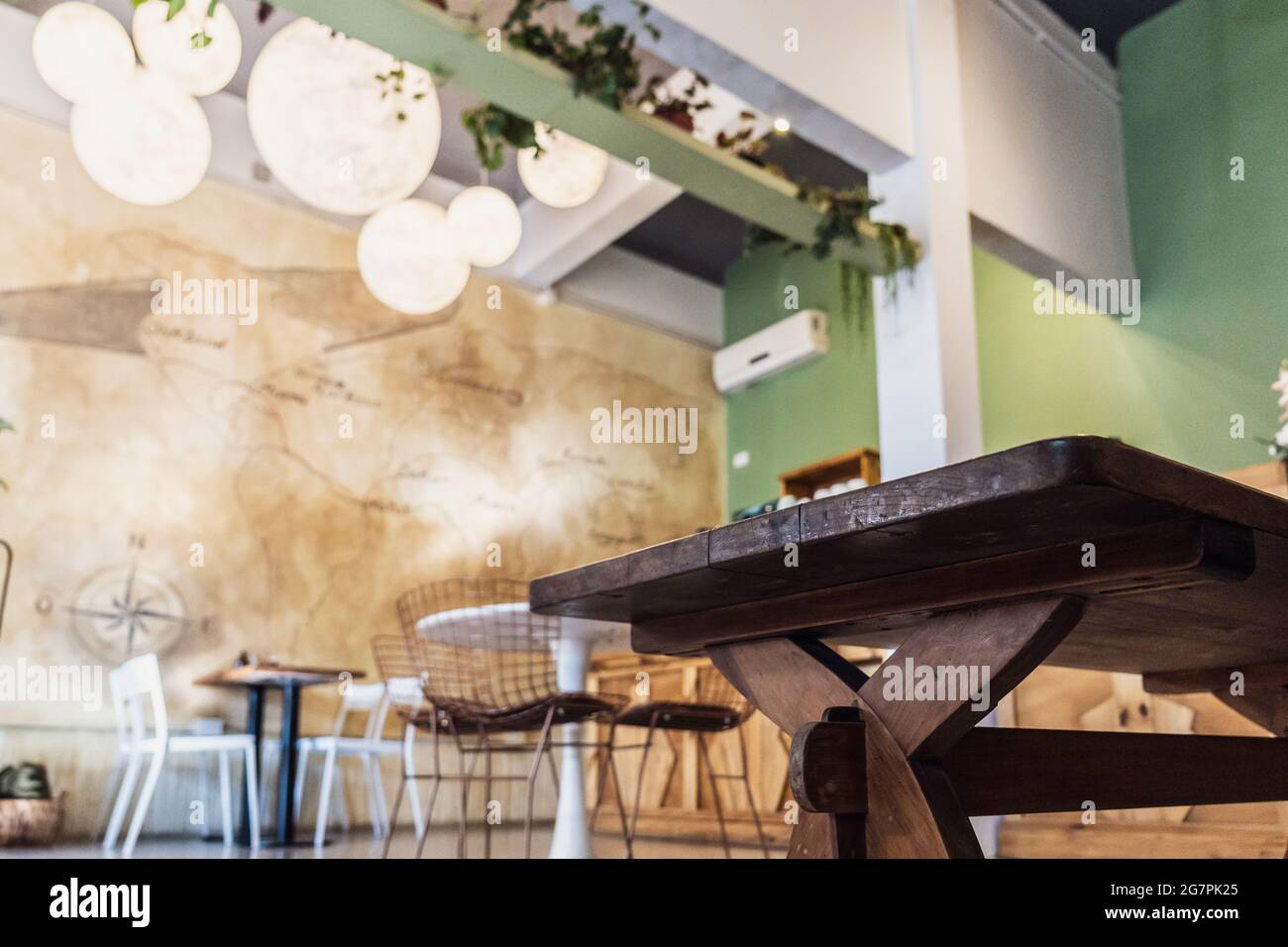 Wooden table in a restaurant with modern design Stock Photo - Alamy