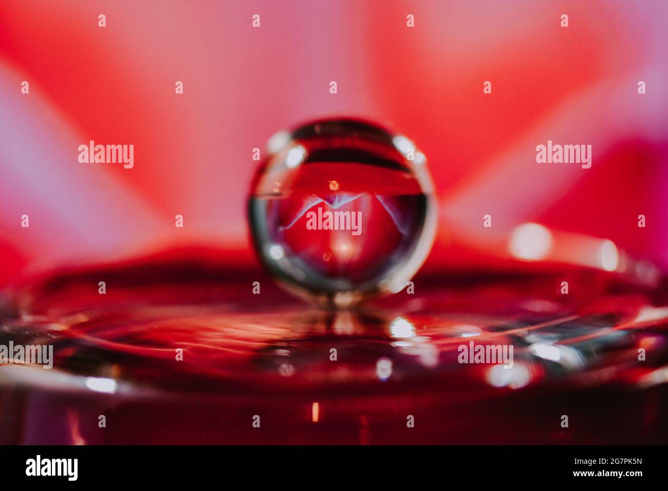 Selective focus shot of a glass ball on a blurry red background Stock ...