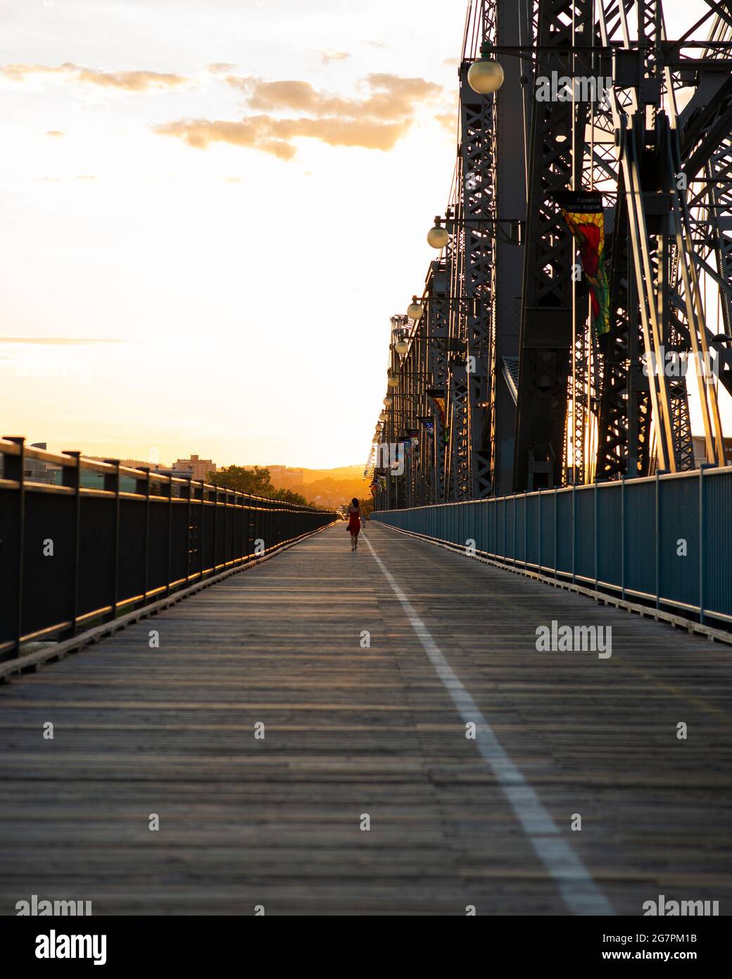 Unique wallpaper with a woman walking on a huge empty bridge under a ...