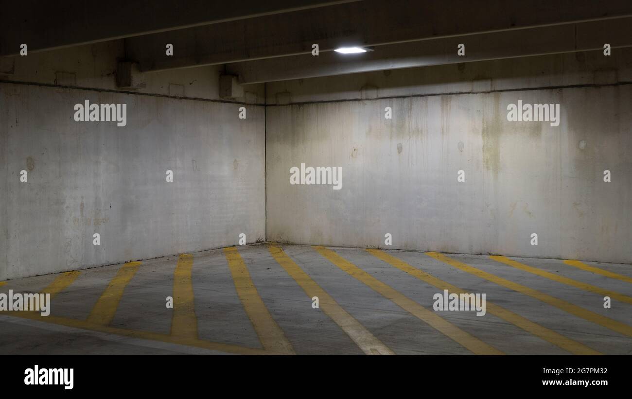 Creepy parking area with shabby walls and yellow stripes on the floor ...