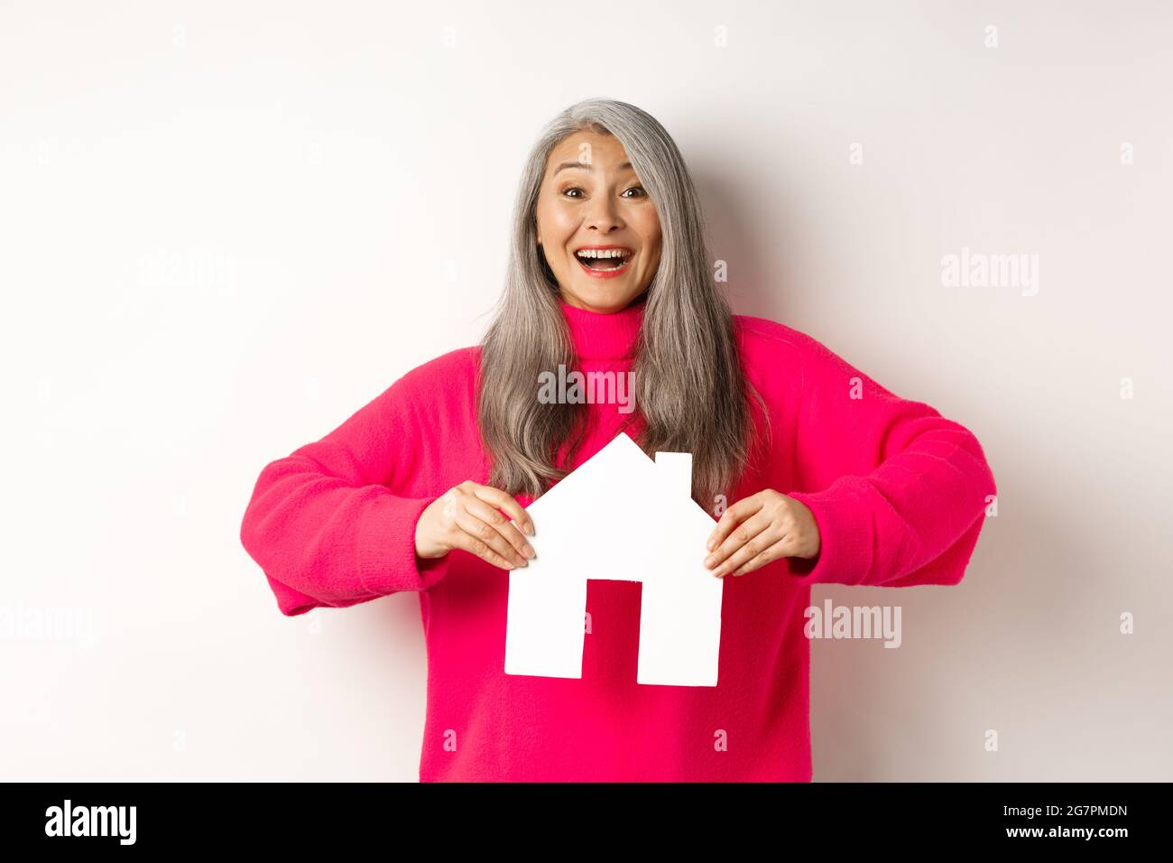 Real estate. Excited asian senior woman looking happy and lucky ...