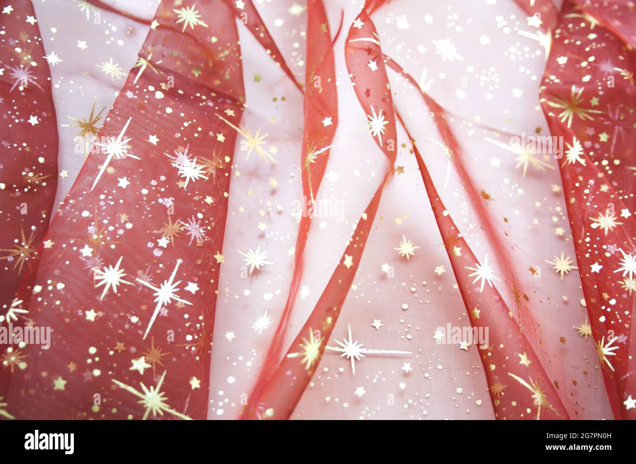 Red organza background with stars on it Stock Photo - Alamy
