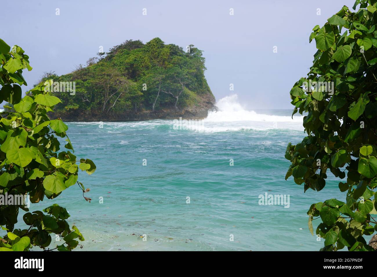 Landscape of the Teluk Asmara Beach surrounded by hills and greenery in ...