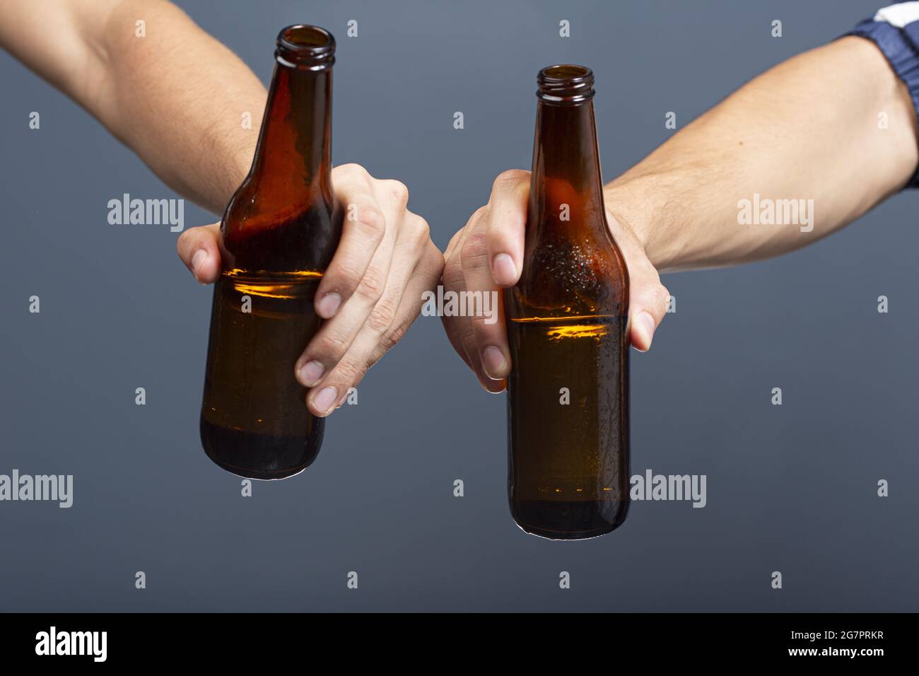 Male hands holding beer bottles Stock Photo - Alamy