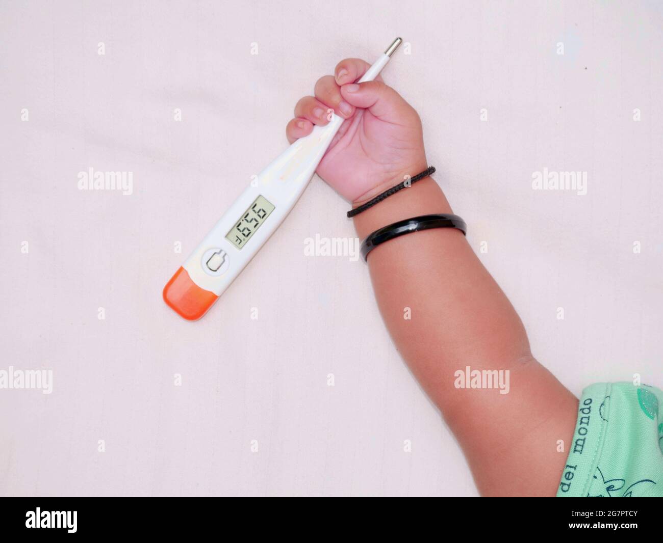 Baby girl hand holding thermometer fever check up for kids medical ...