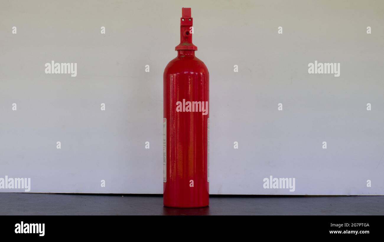 A Small Red Fire Extinguisher Against a White Background Stock Photo ...