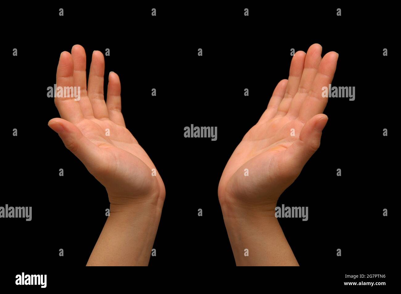 Isolated shot of hands lifted up when praying hand gesture on a black ...