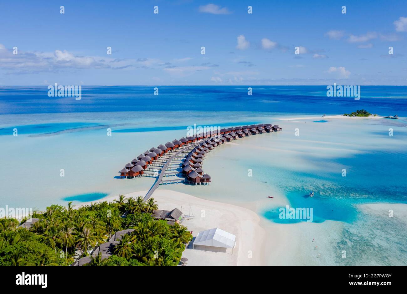 Aerial view of the Maldivian island with tourist bungalows on a coral ...
