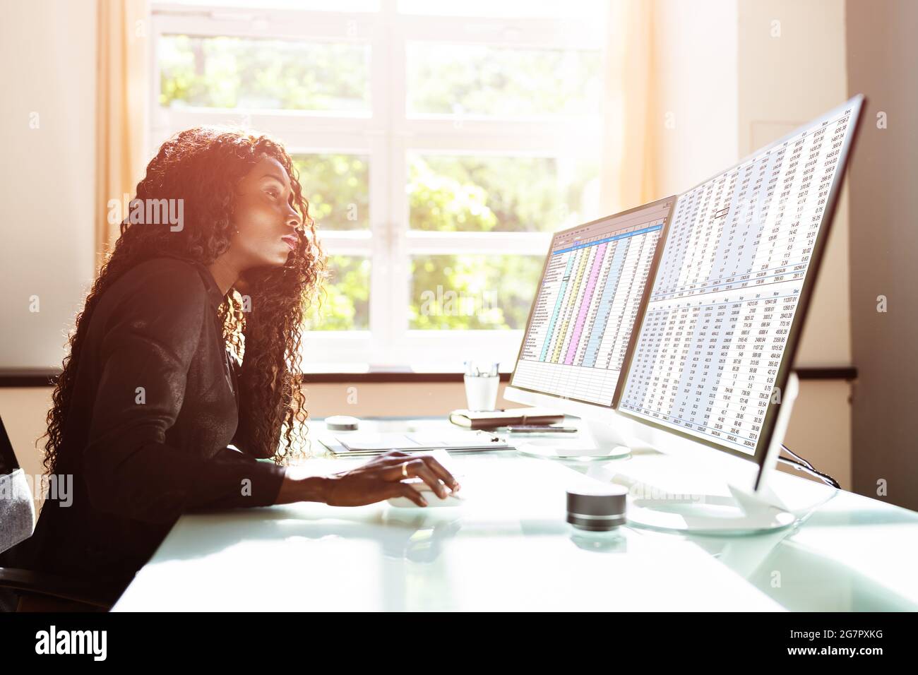 Data Analyst African Woman Using Spreadsheet On Computer Stock Photo ...