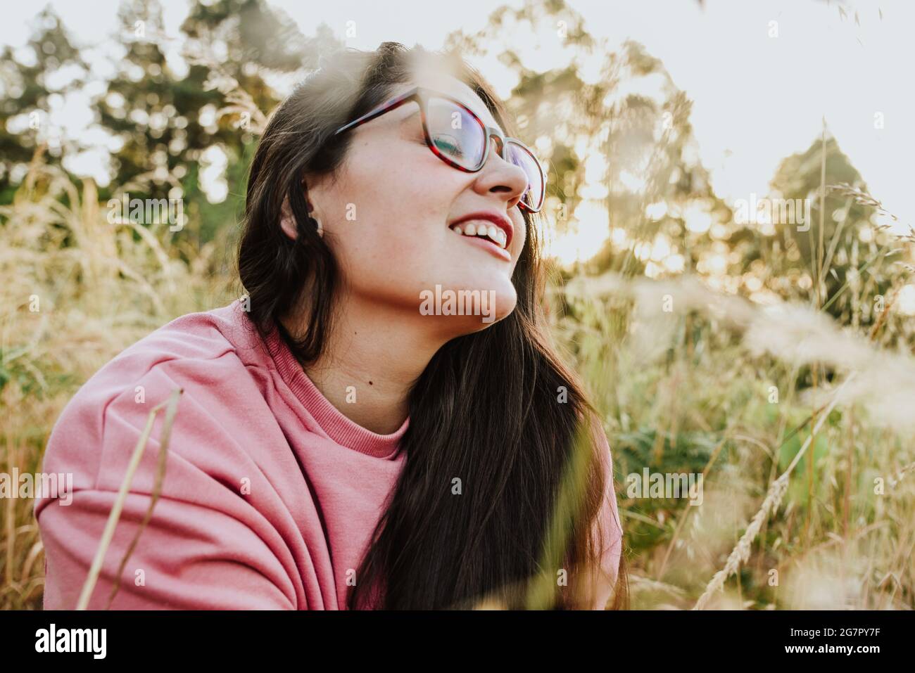Girl smiling in the middle of the field in midsummer at sunset Stock ...