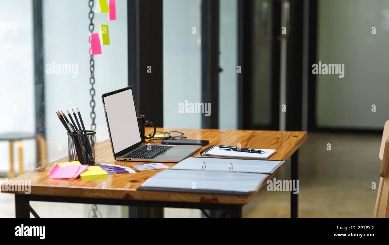Content creator working desk with empty screen laptop, stationery ...