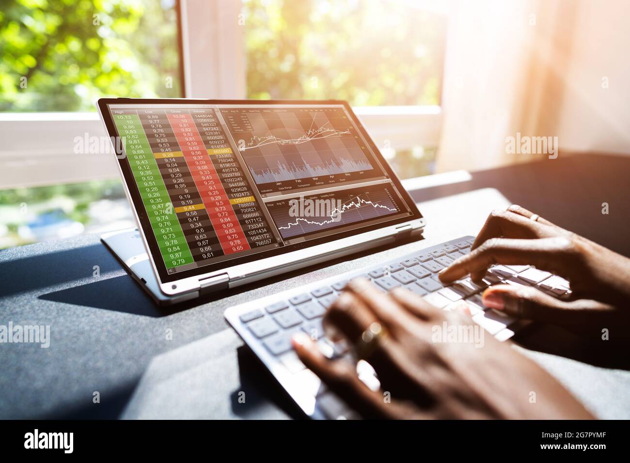 African Woman Trading Stock Market Online Using Laptop Stock Photo - Alamy