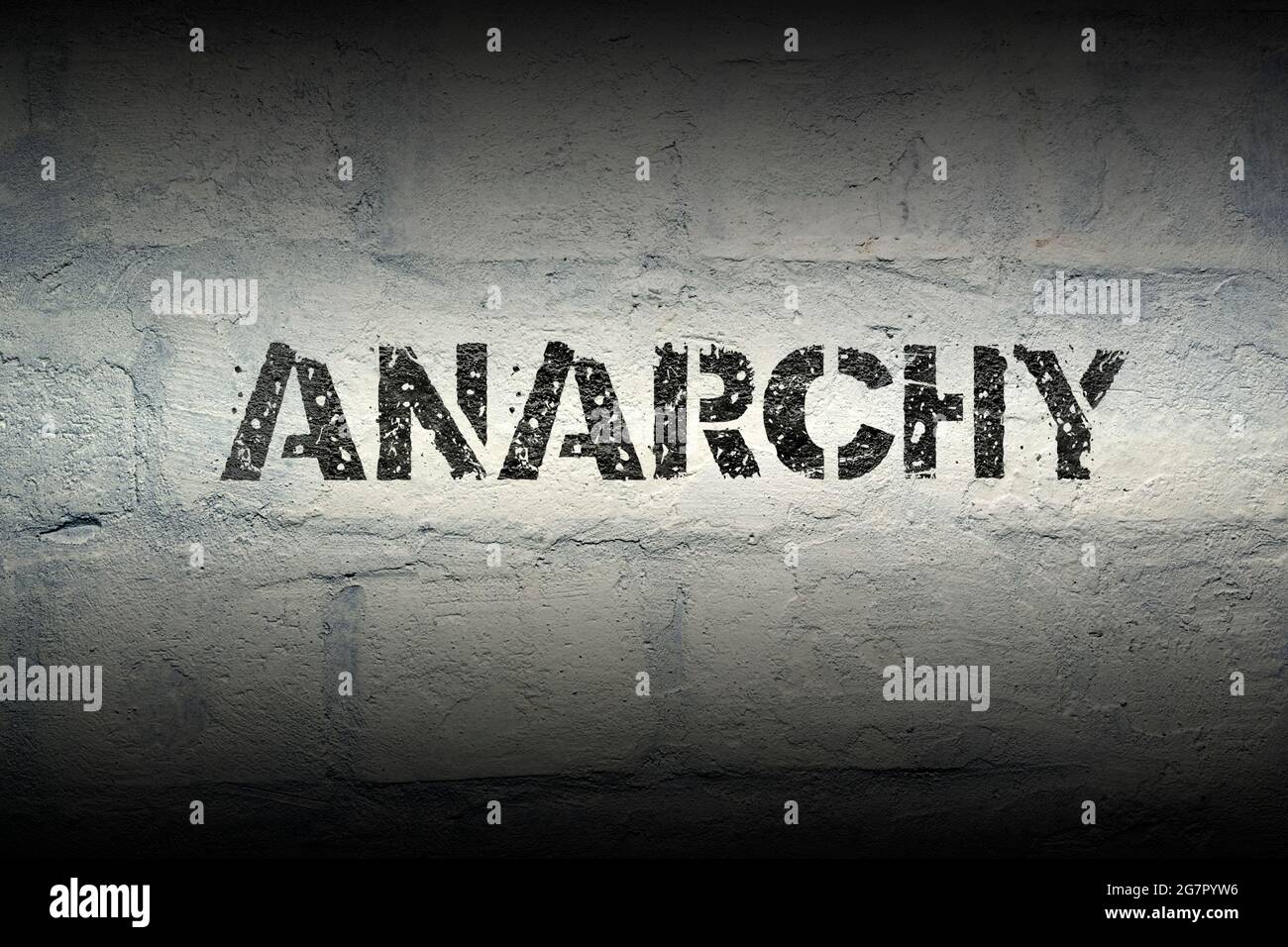 anarchy stencil print on the grunge white brick wall Stock Photo - Alamy
