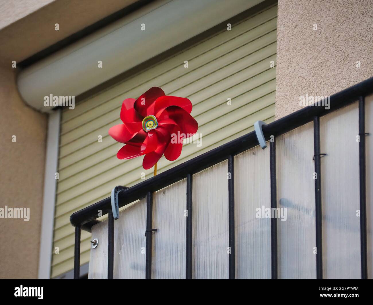 Low angle shot of a red pinwheel in a balcony Stock Photo - Alamy
