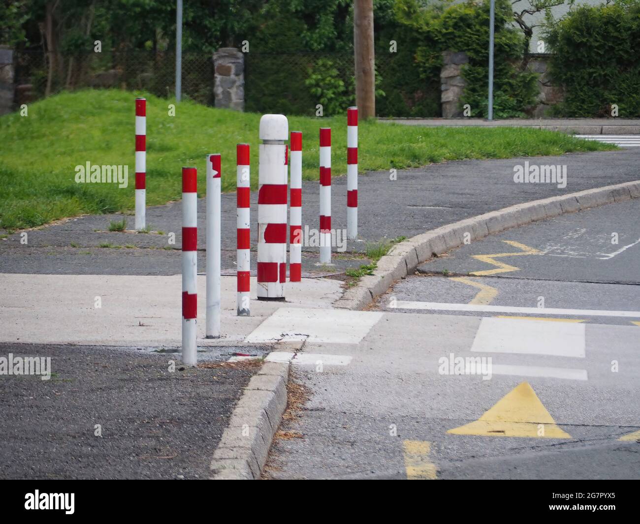 Empty street with markings and anti-parking posts Stock Photo - Alamy