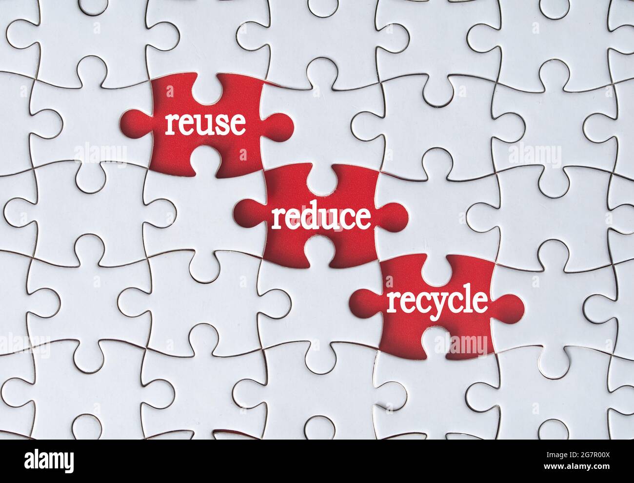 Business concept. Jigsaw puzzle with text reuse, reduce and recycle on ...