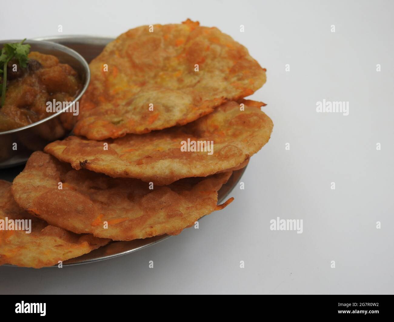 Carrot puri with vegetable curry on big plate isolated on white ...