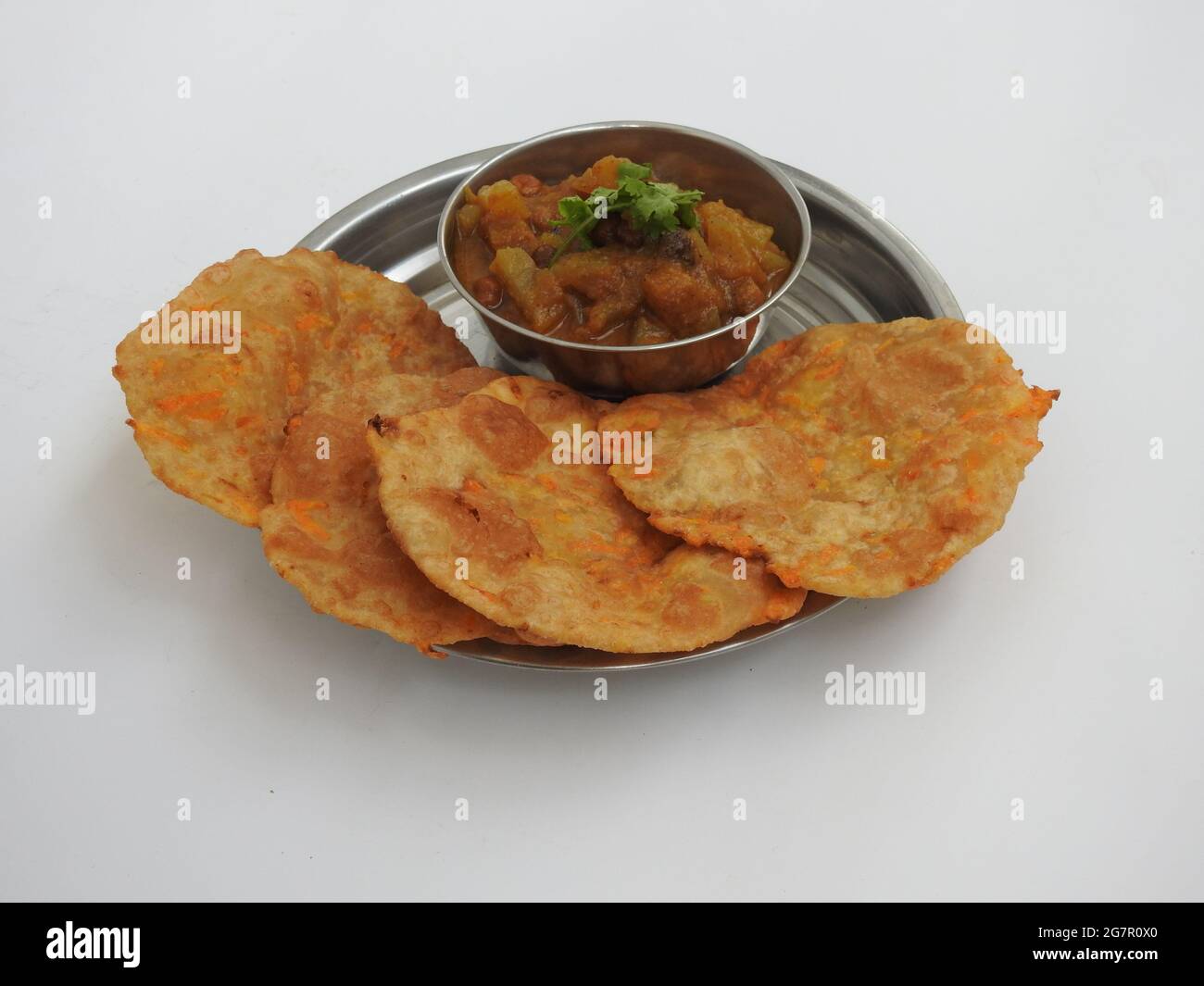 Carrot puri with vegetable curry on big plate isolated on white ...