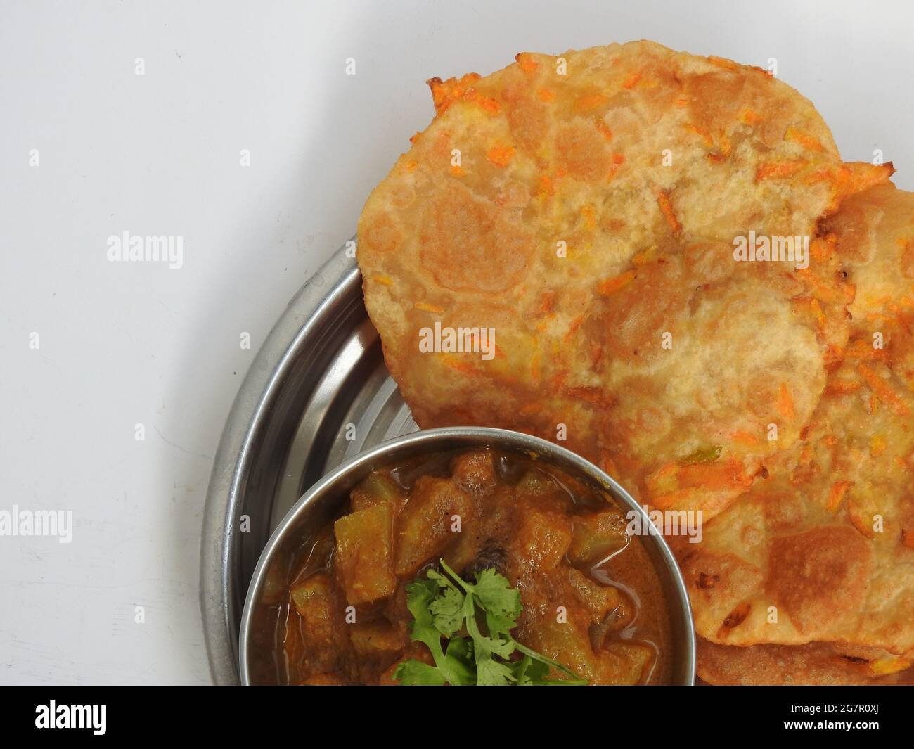 Carrot puri with vegetable curry on big plate isolated on white ...