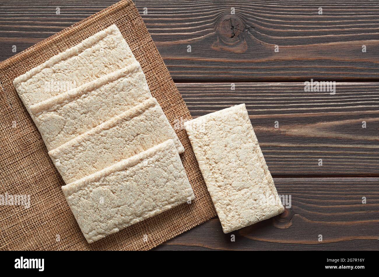 Crispy rye bread on brown wooden table, top view. Dietary food Stock ...