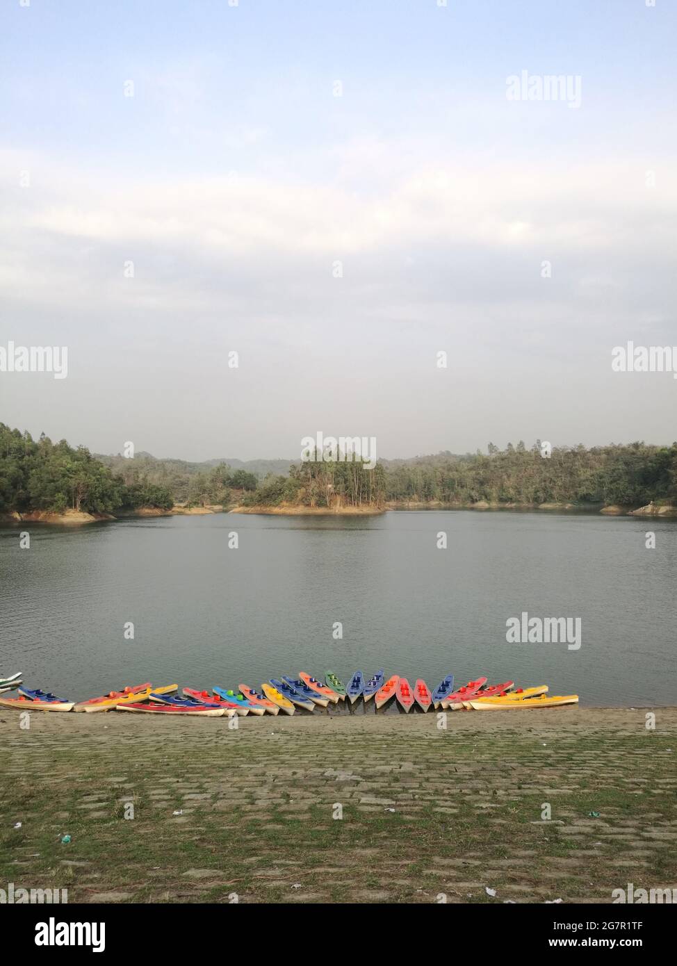 Vertical shot of colorful children's rowing boats on a lake near the ...