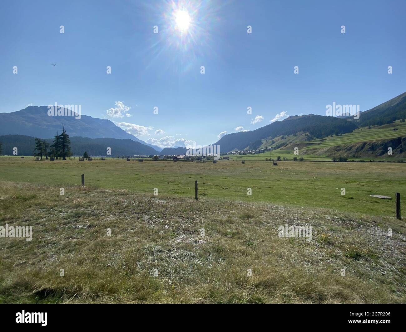 Closeup shot of greenery-covered lands with high mountains in the ...
