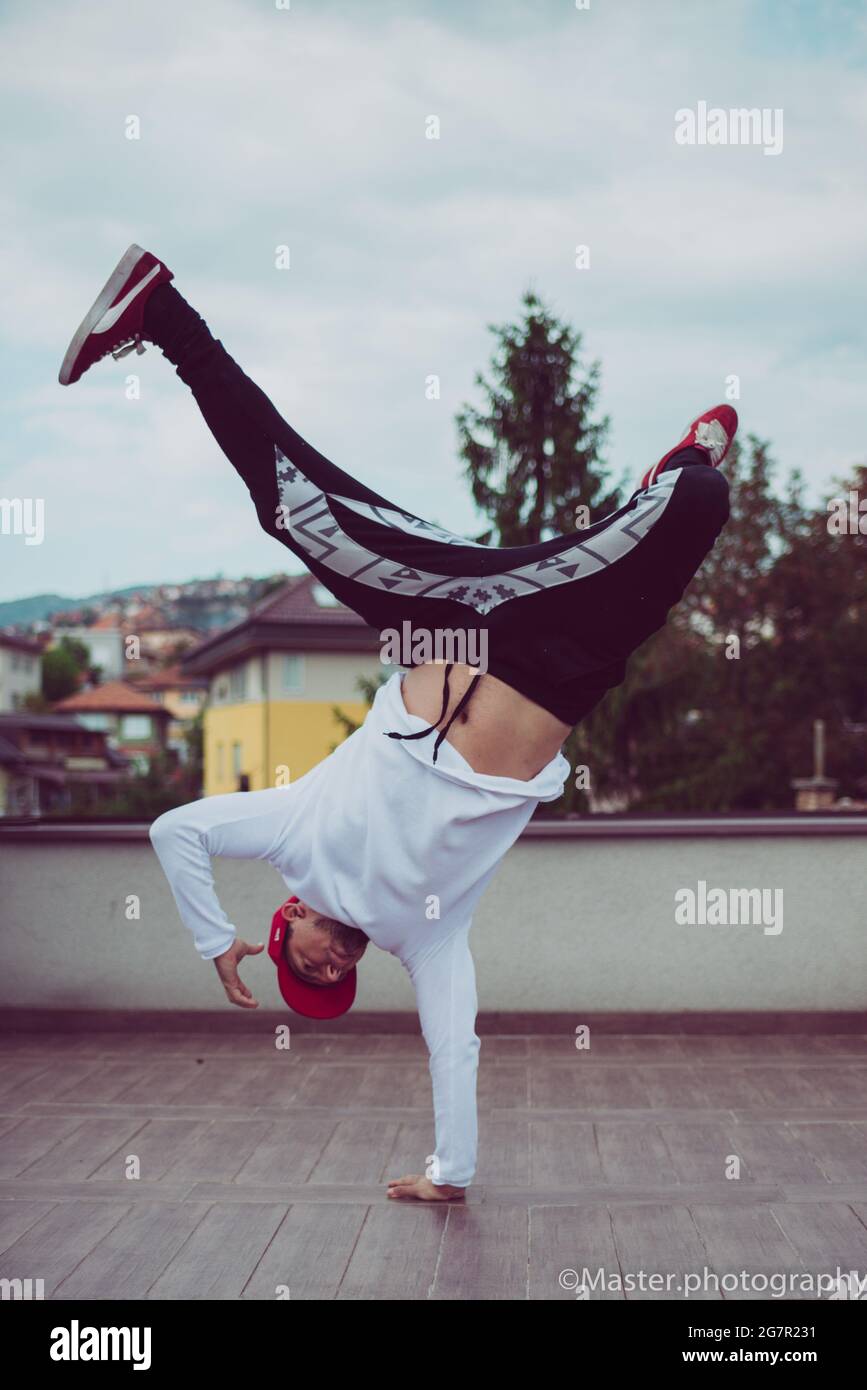 Vertical image of a breakdancer man with a red cap and sneakers from ...